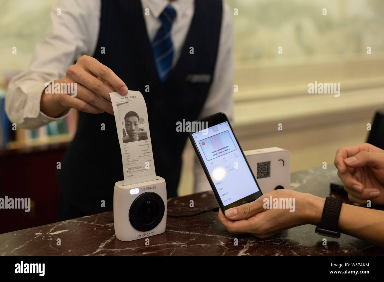 A Chinese mobile phone user uses his electronic identification card in ...
