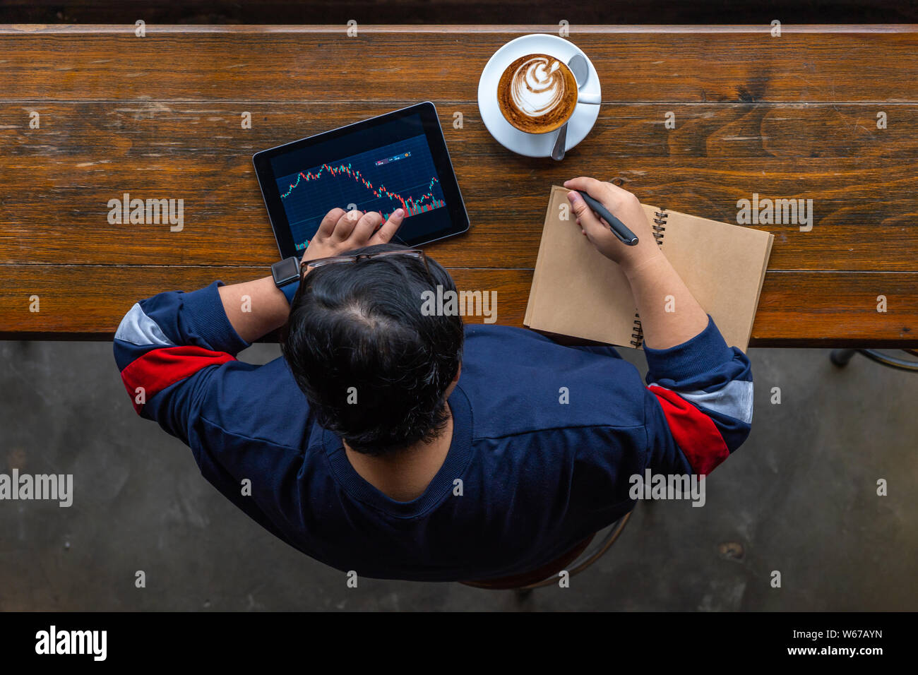 Top view of investor looking at candlestick chart on tablet Stock Photo ...