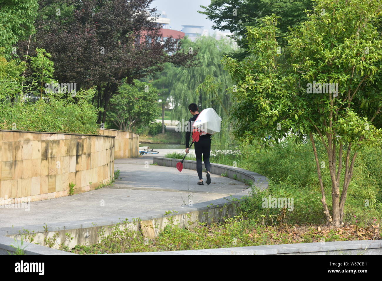 34-year-old Chinese gym teacher Sun Hua carries his boat before going ...