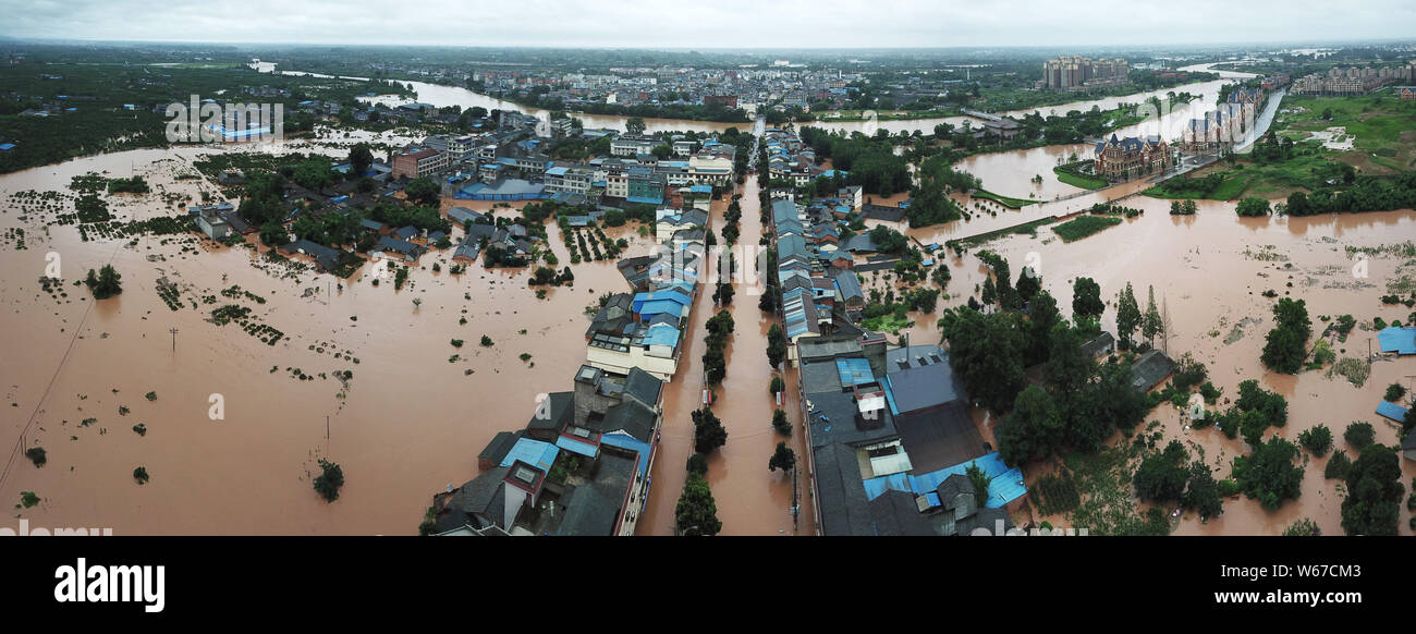 An aerial view of residential houses and fields submerged by floodwater ...