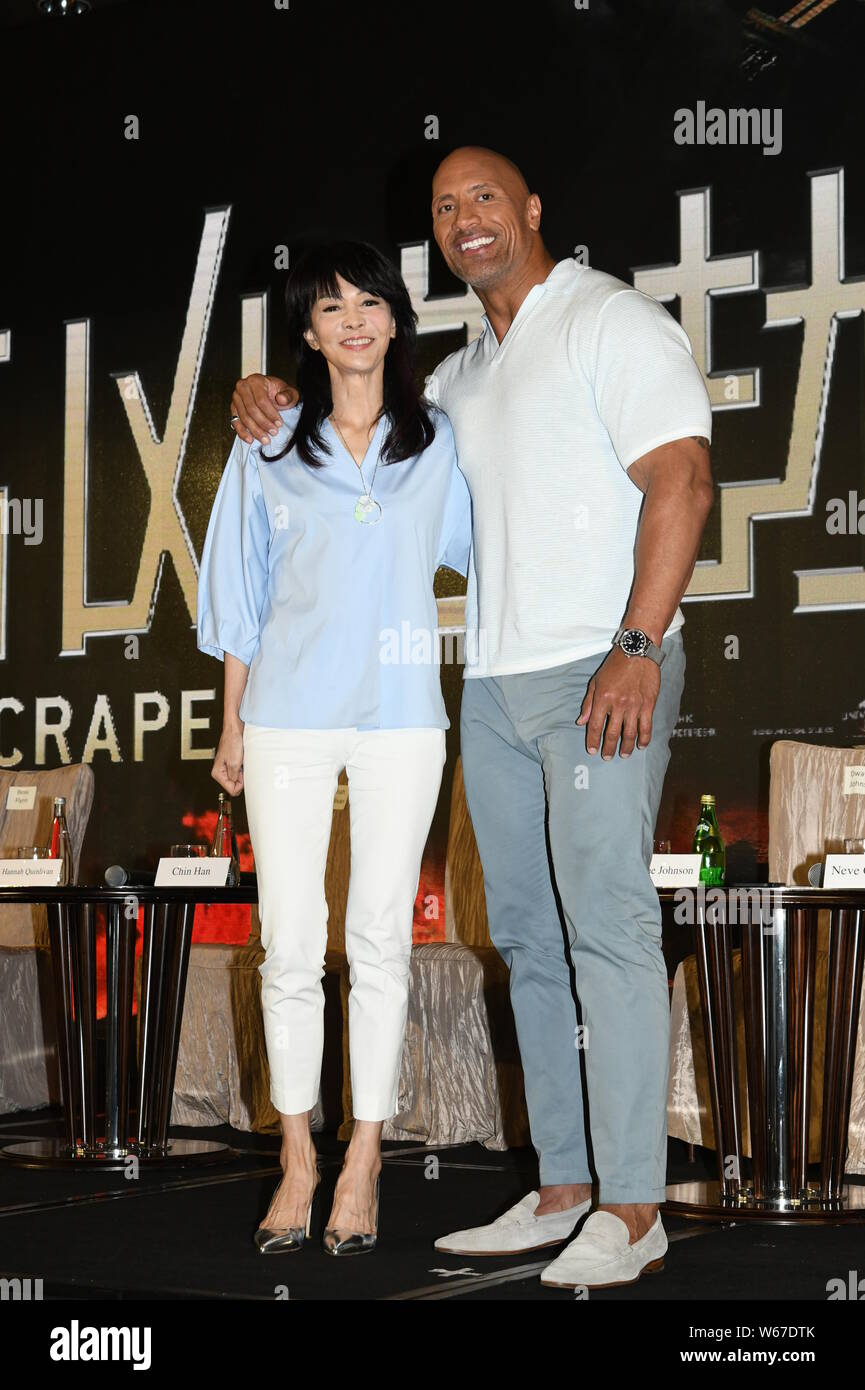 American actor Dwayne Johnson, right, poses for photos with a fan ...