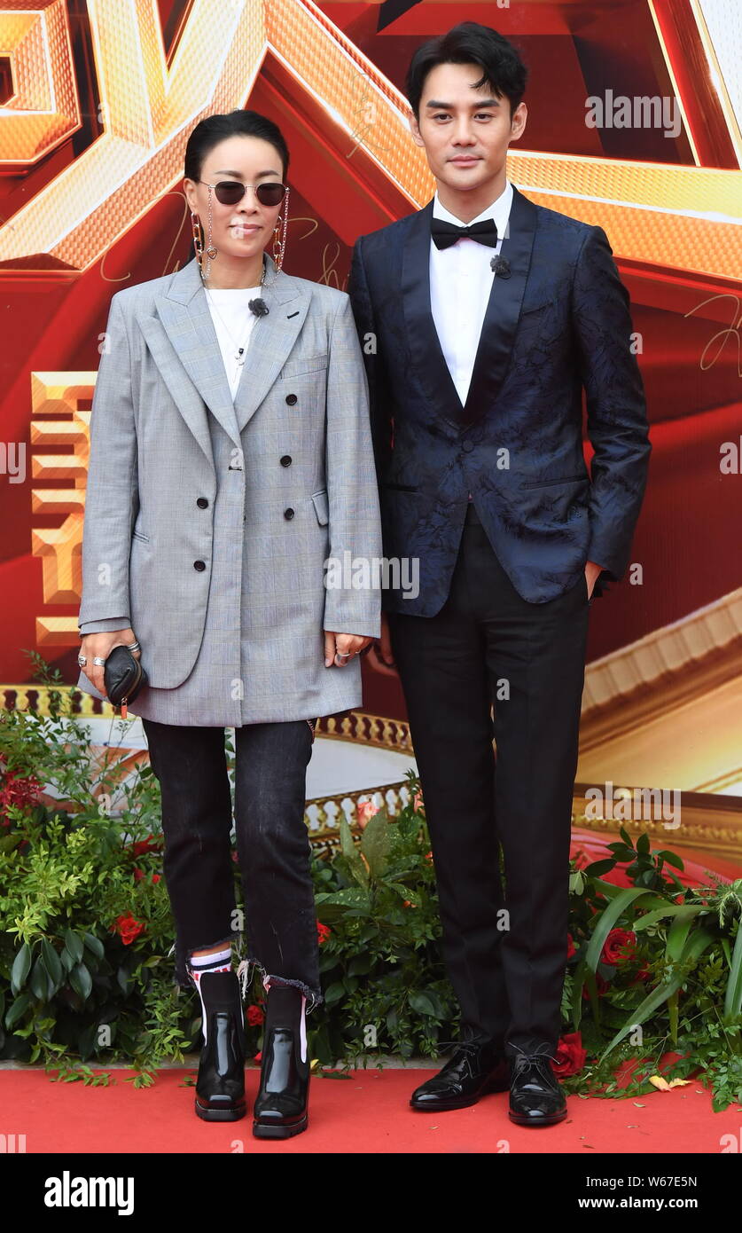 Chinese vocalist Na Ying, left, and actor Wang Kai pose as they arrive ...