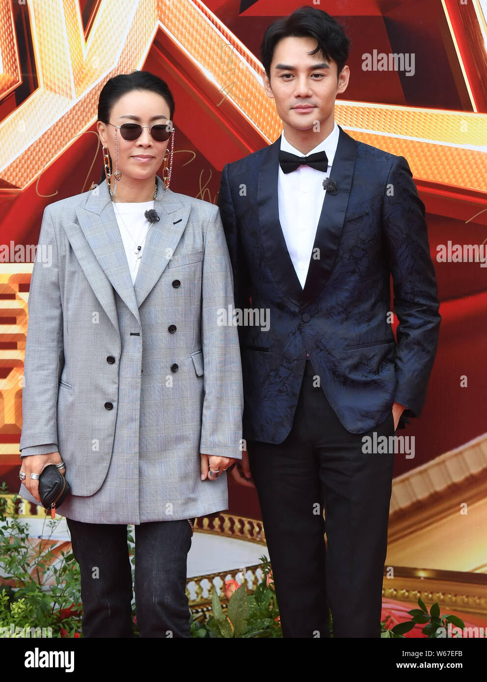 Chinese vocalist Na Ying, left, and actor Wang Kai pose as they arrive ...