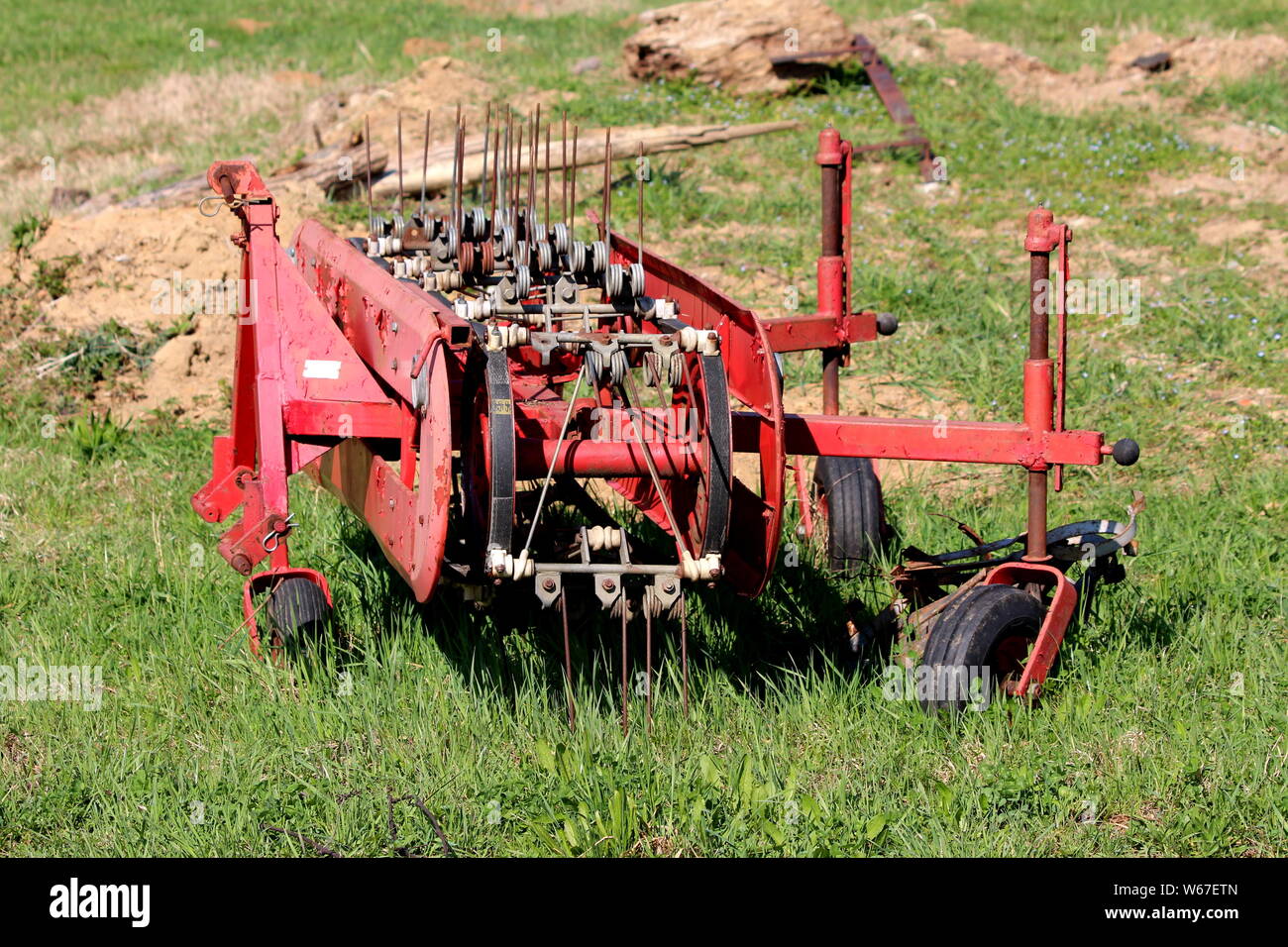 Dilapidated agricultural farming hay tedder turning equipment left in ...