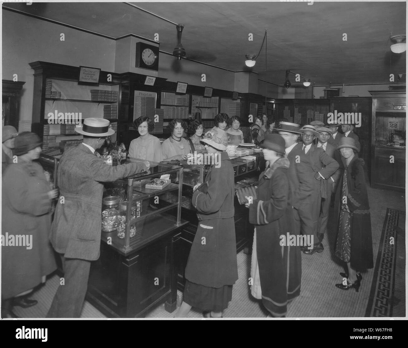 Mrs. Snyders Candy Shop. Showing customers standing at counter behind ...