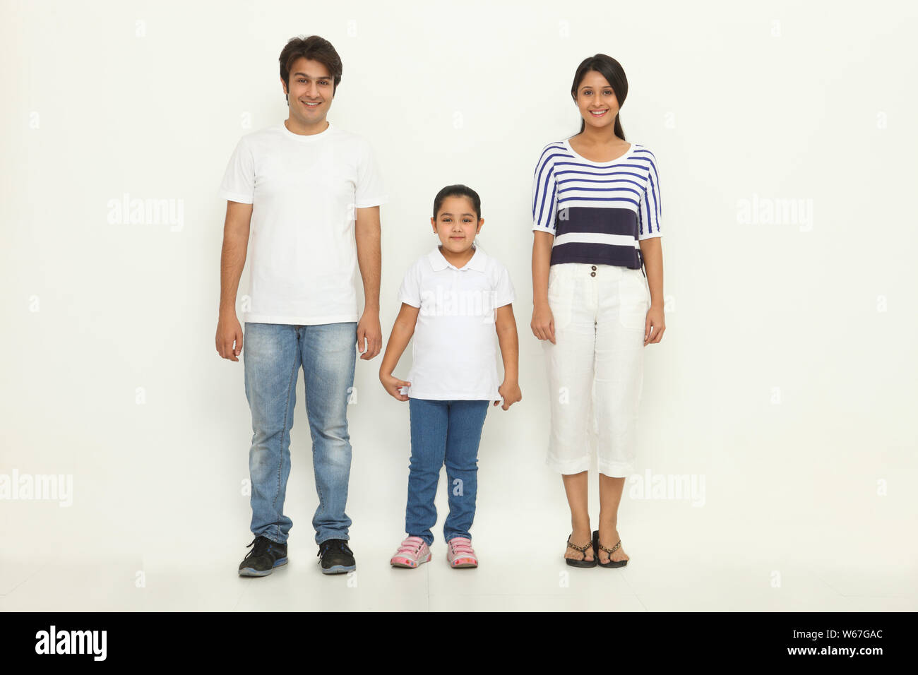 Family standing together and smiling Stock Photo - Alamy
