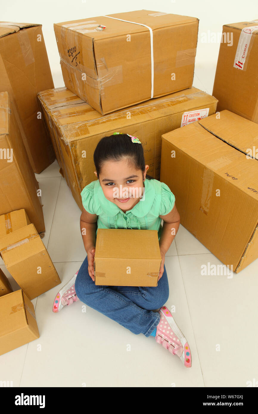 Girl sitting with cardboard boxes Stock Photo - Alamy