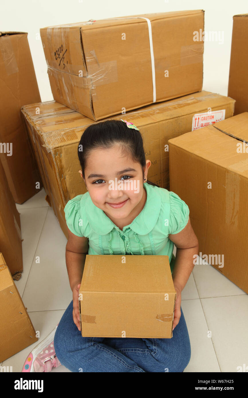 Girl sitting with cardboard boxes Stock Photo - Alamy