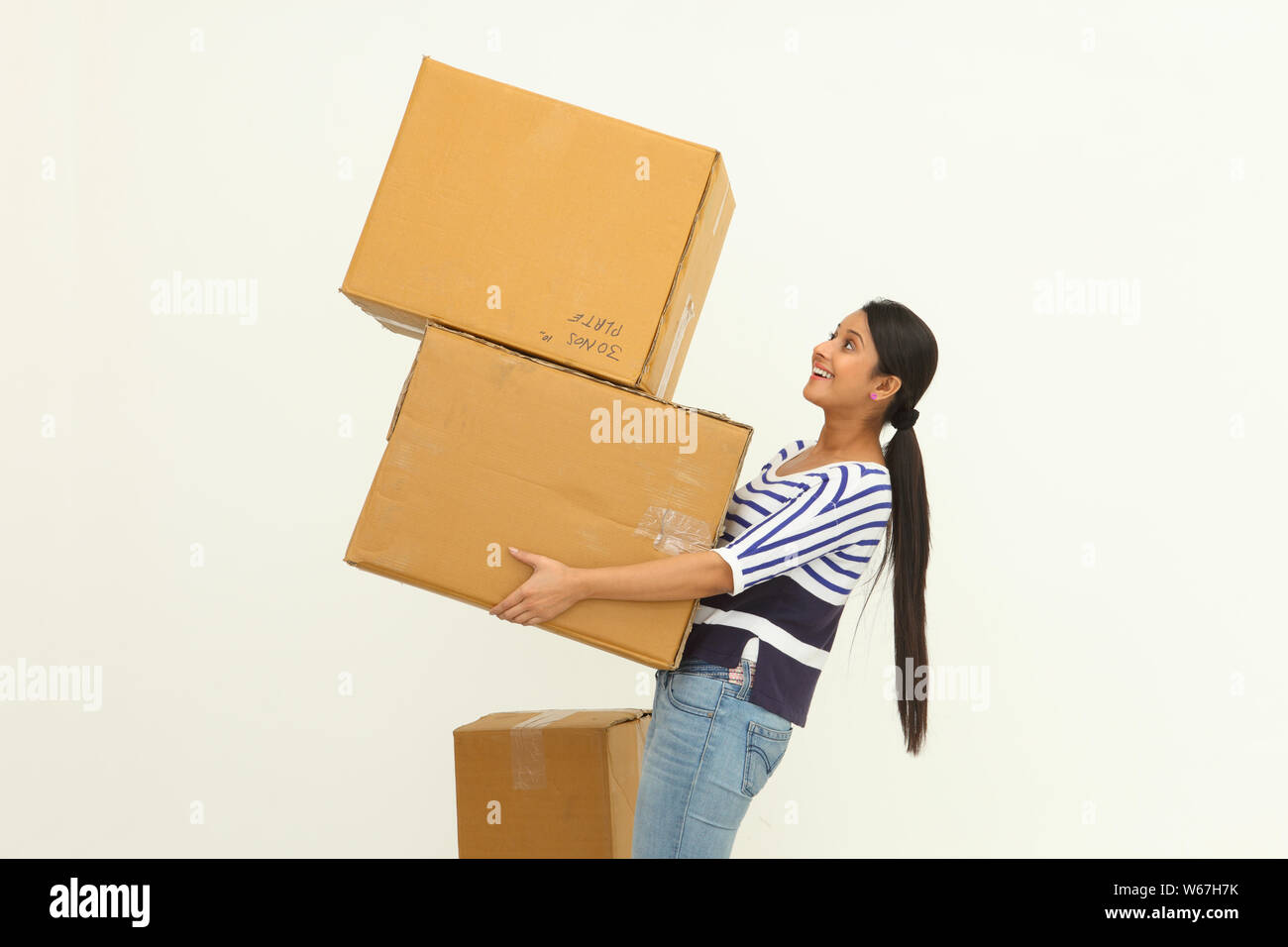 Woman picking up boxes hi-res stock photography and images - Alamy