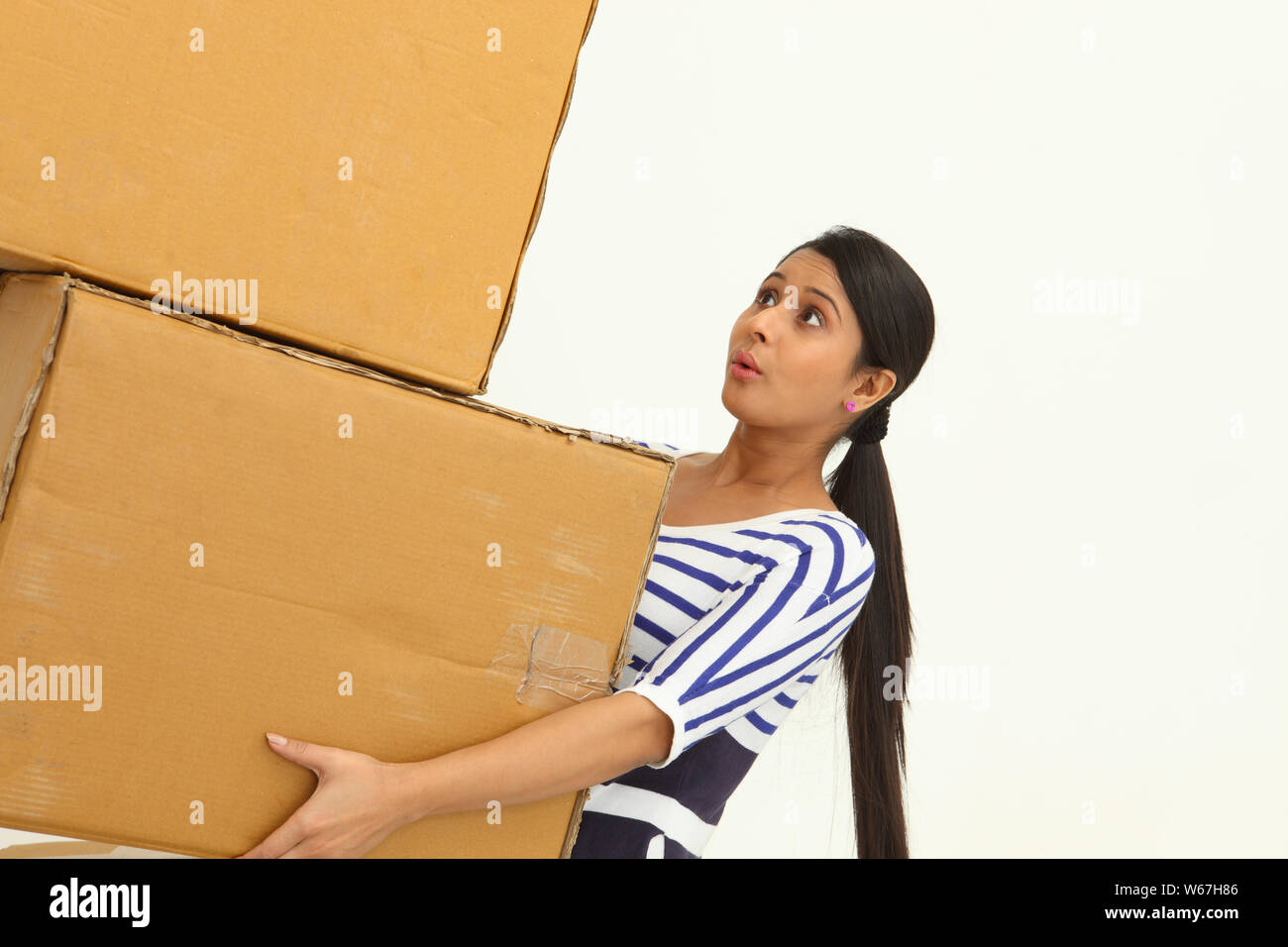 Woman stacking cardboard boxes hi-res stock photography and images - Alamy