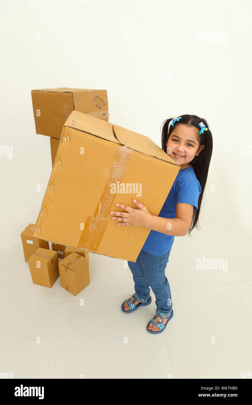 Girl carrying cardboard Box Stock Photo - Alamy