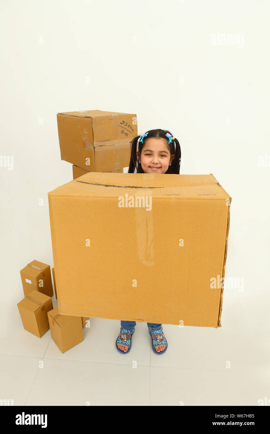 Girl holding very heavy brown cardboard box on the white Stock Photo ...