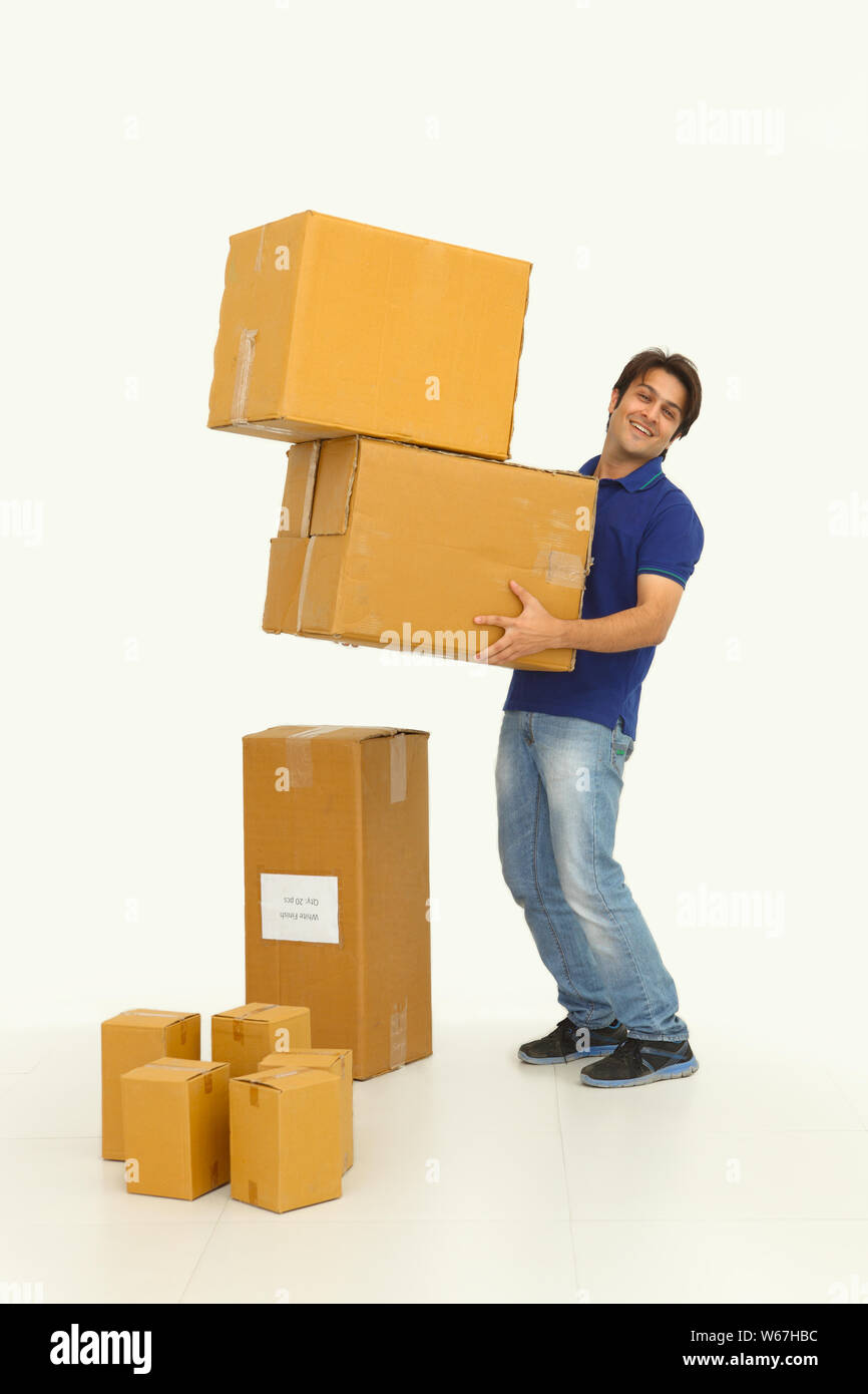 Man carrying cardboard boxes and smiling Stock Photo - Alamy