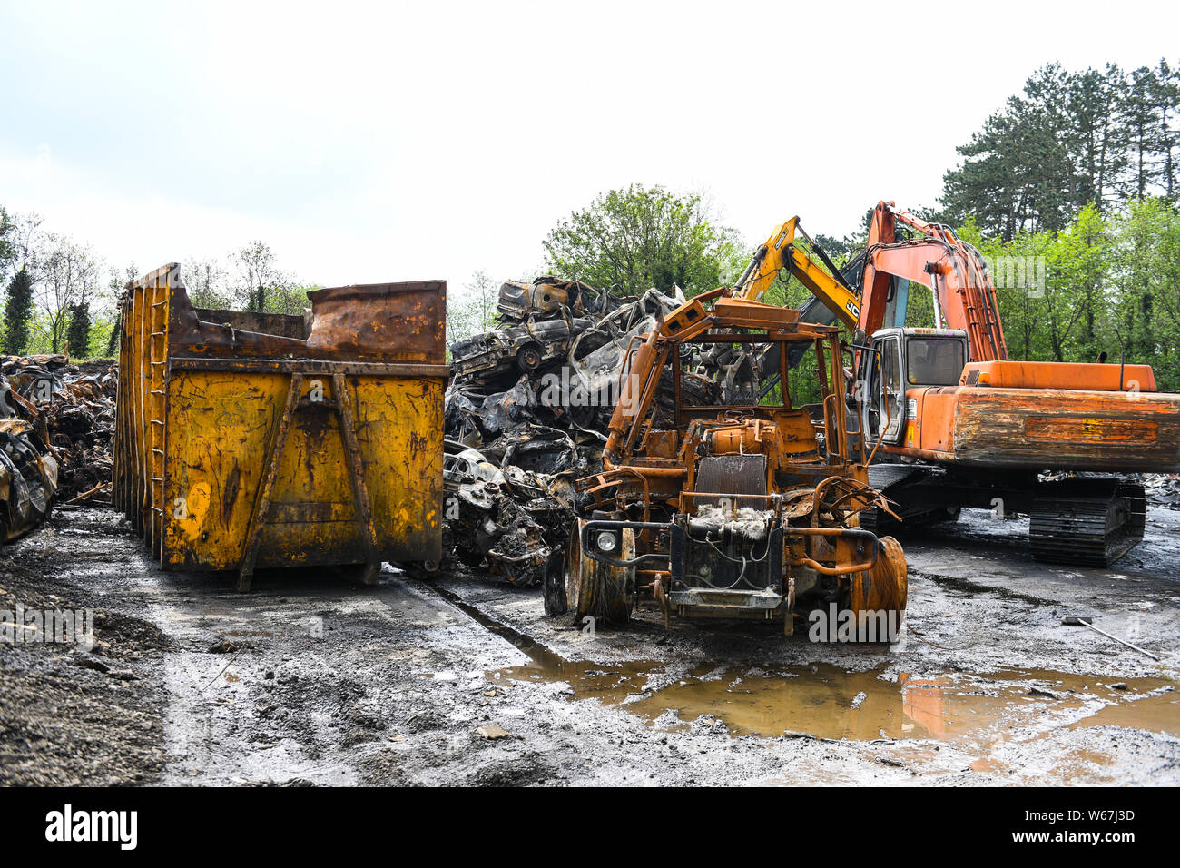 Piles of burnt cars are pictrured at a scrap yard in Ammanford, Wales ...