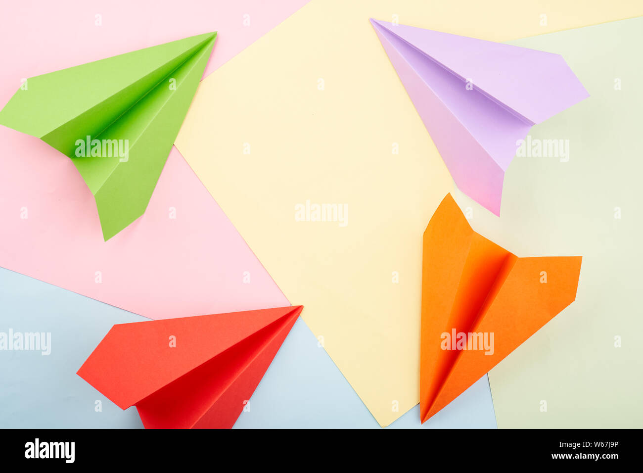 Circle of origami color paper planes on the color background Stock ...