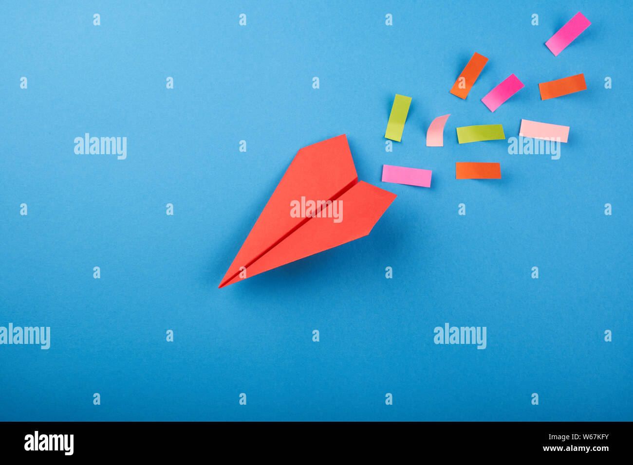 Red paper plane on the blue background Stock Photo - Alamy