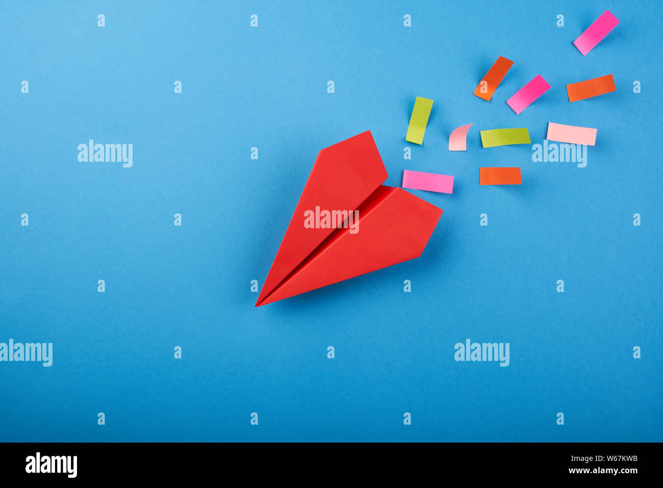 Red paper plane on the blue background Stock Photo - Alamy