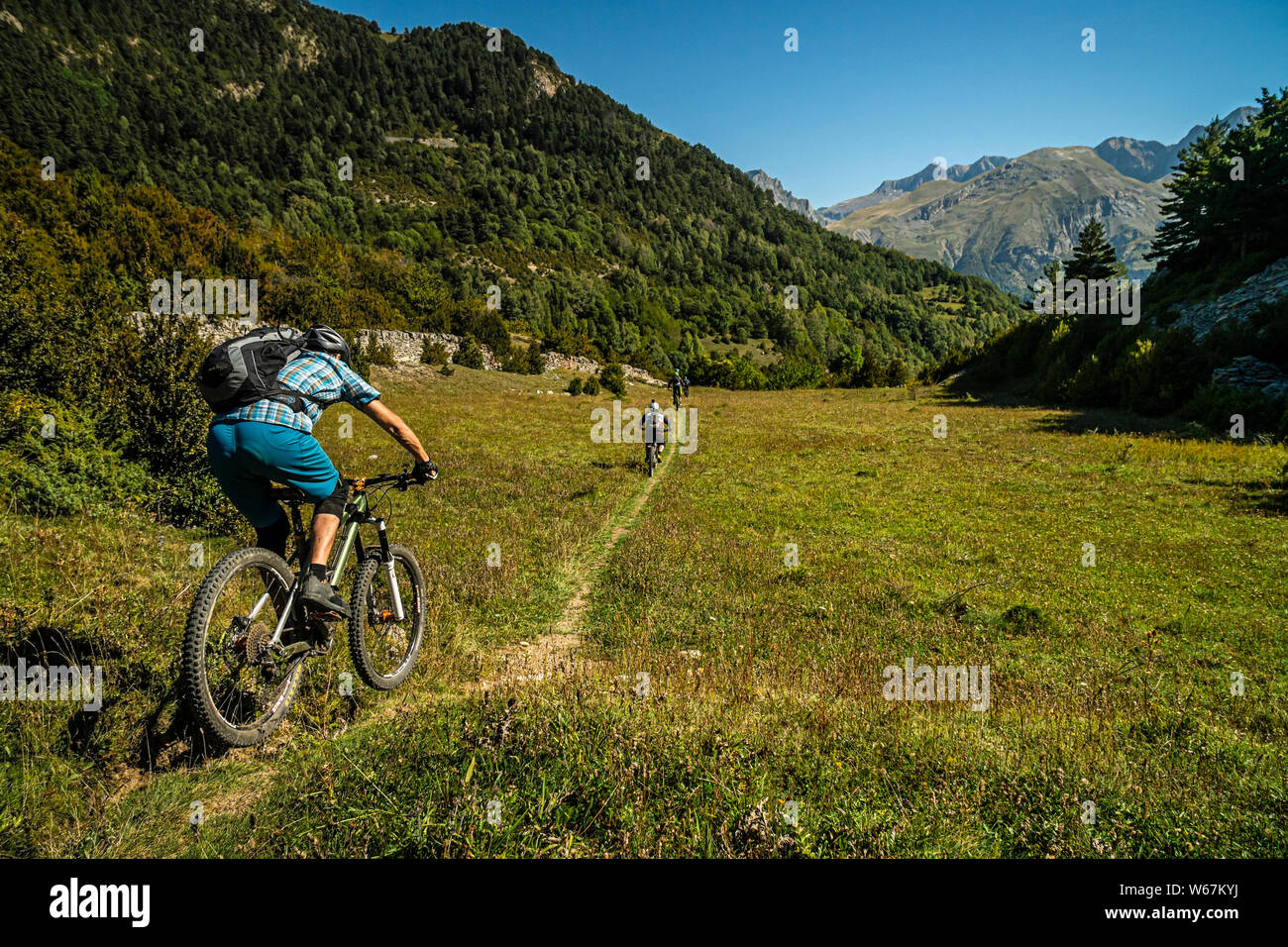 BIESCAS, HUESCA, SPAIN. A group of mountain bikers riding a narrow ...