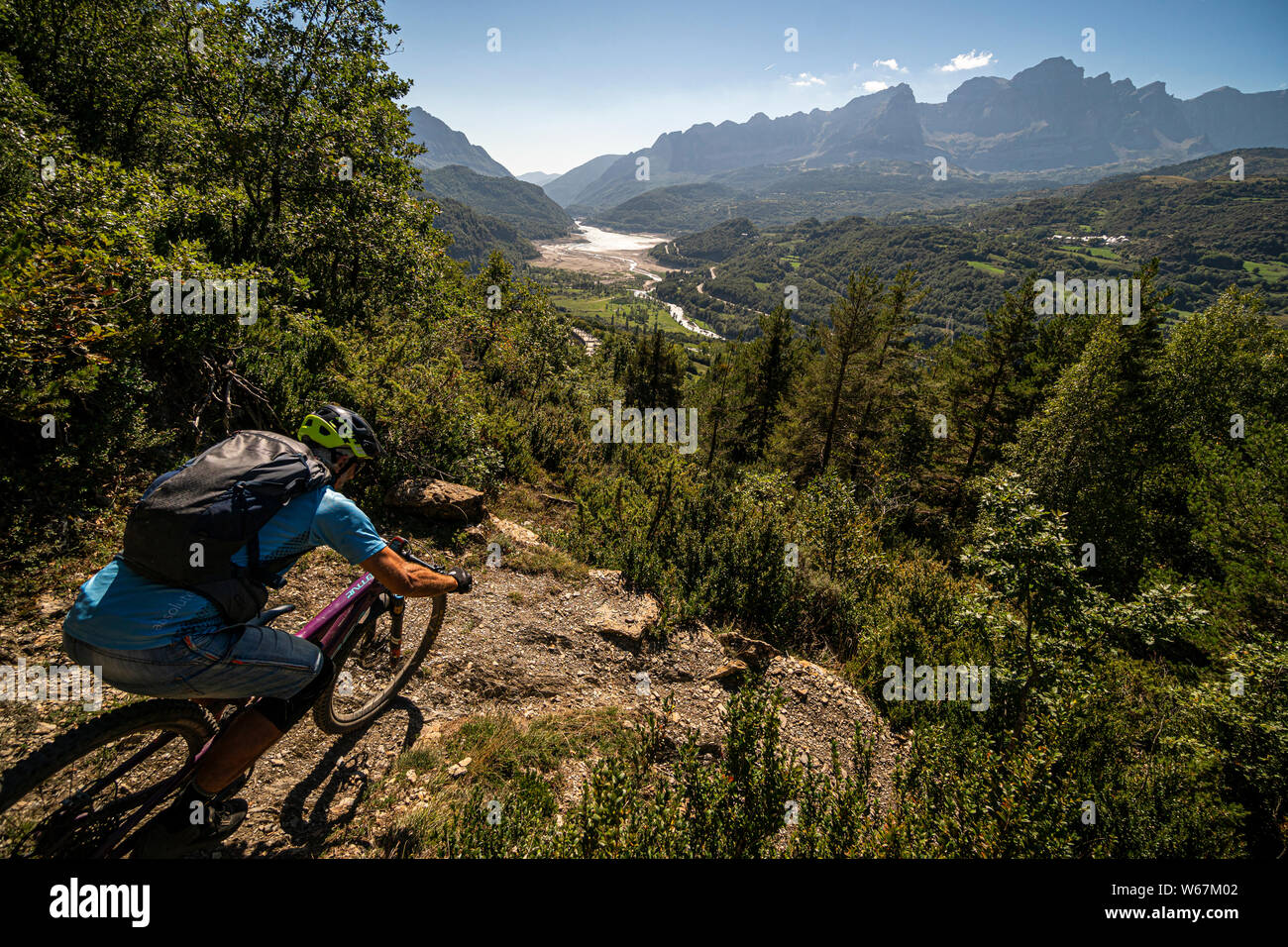 BIESCAS, HUESCA, SPAIN. A mountain biker riding a difficult narrow ...