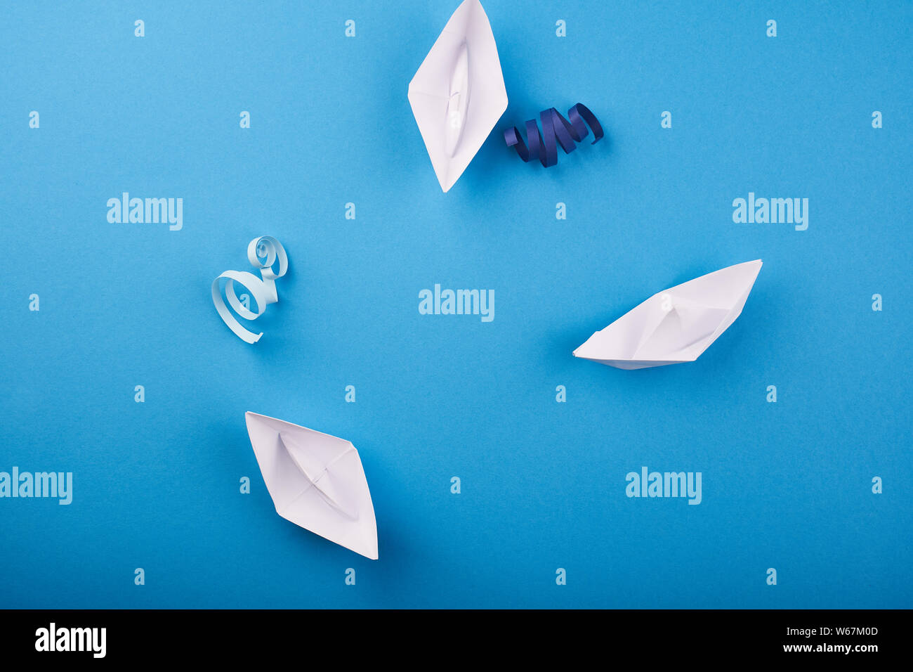 White paper ships on the blue background Stock Photo - Alamy