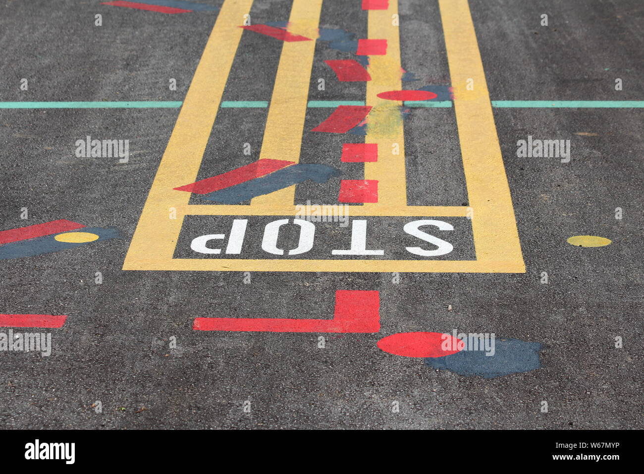 Stop warning written on paved surface at colorful street line testing ...