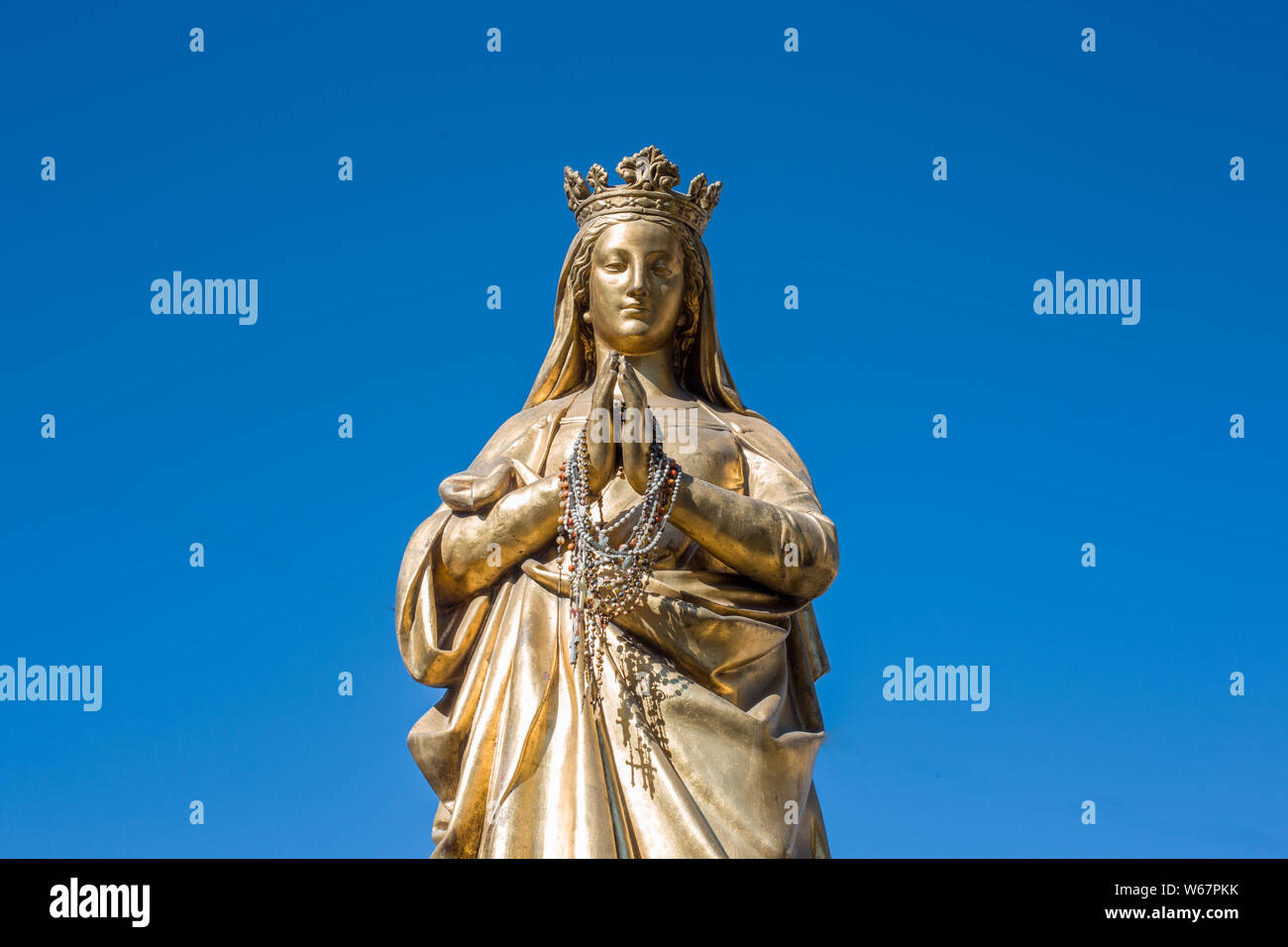 Catholic statue with blue sky background Stock Photo - Alamy