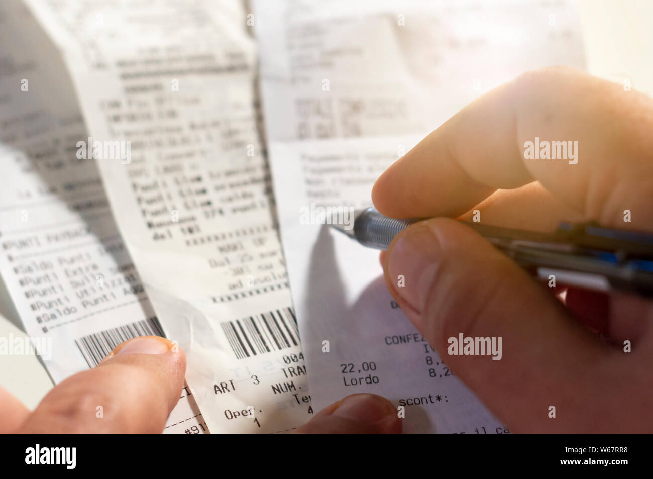 checking a receipt by analyzing the numbers, expenses and profits ...