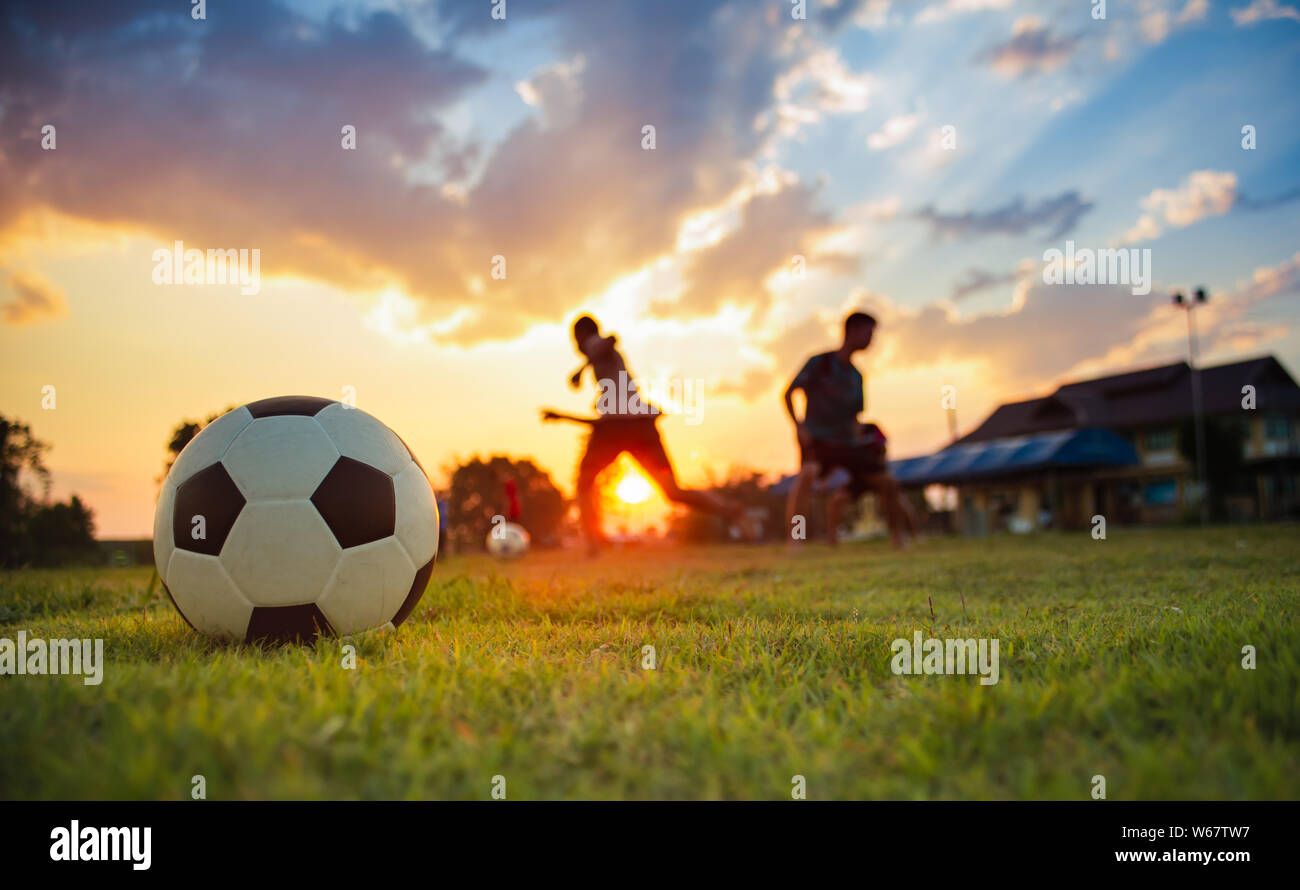 Silhouette action sport of kids having fun playing soccer football for ...