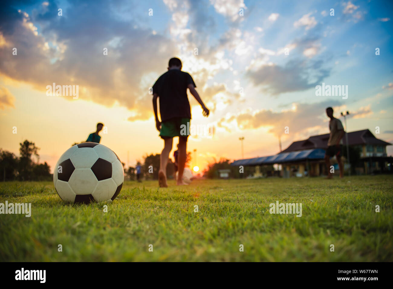 Silhouette action sport of kids having fun playing soccer football for ...