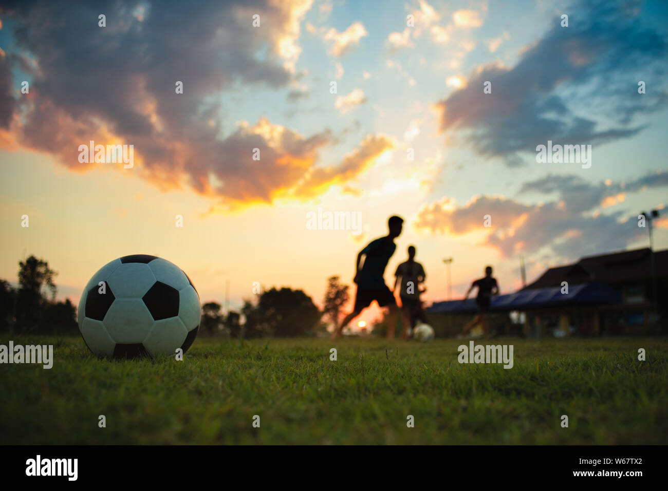 Silhouette action sport of kids having fun playing soccer football for ...