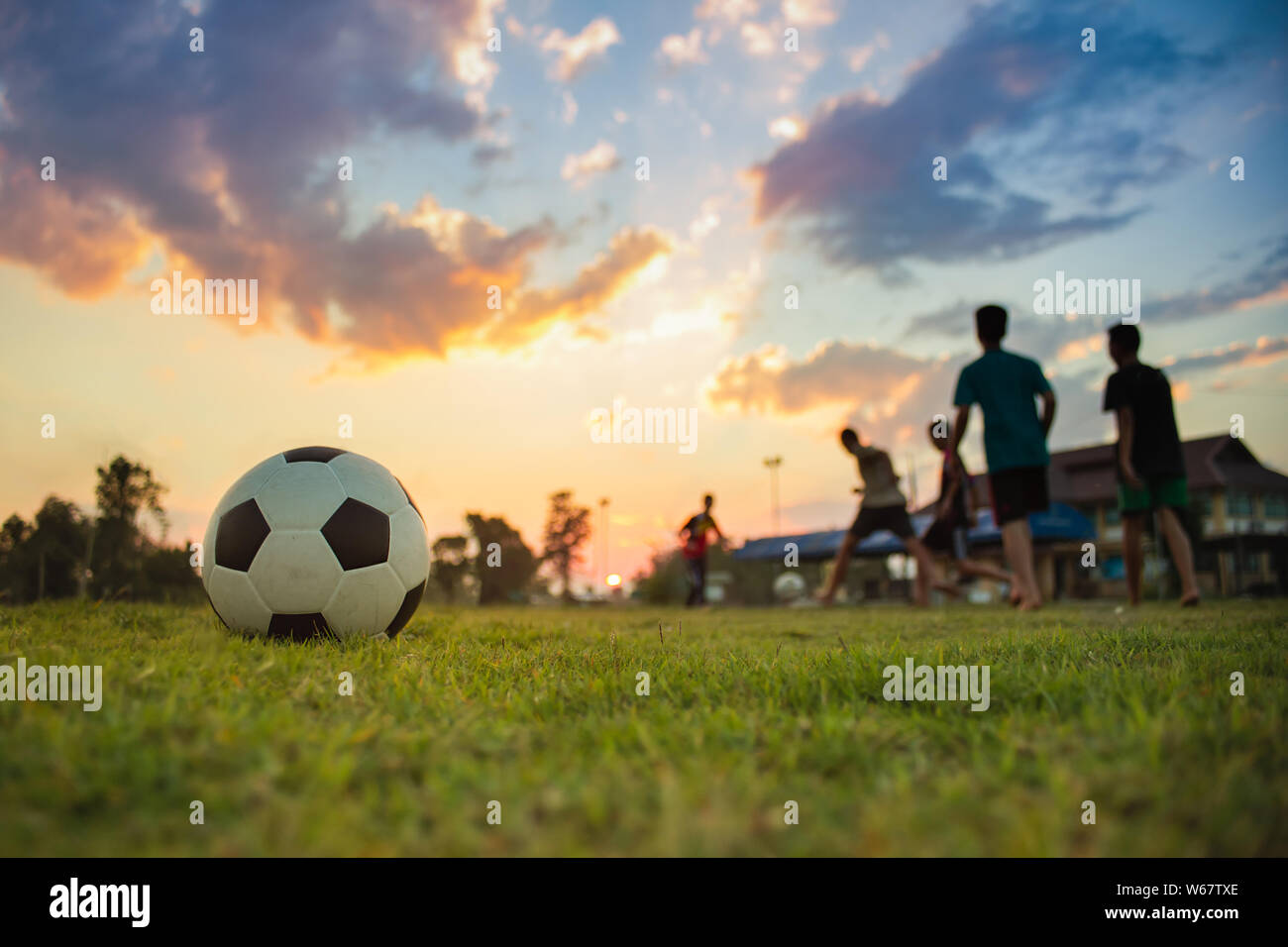 Silhouette action sport of kids having fun playing soccer football for ...