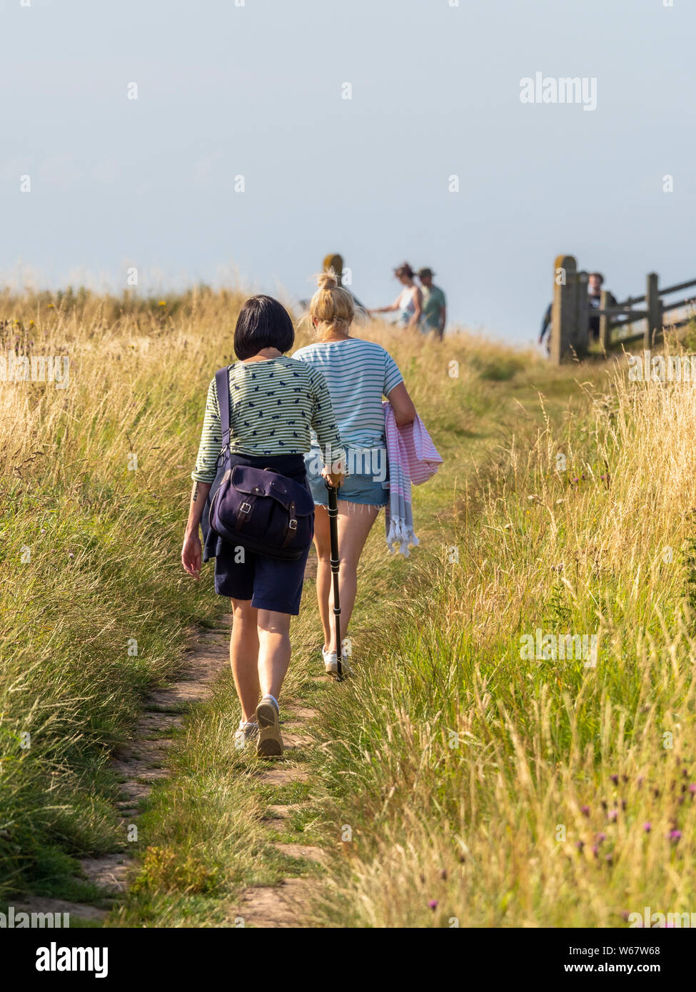 Walkers on coastal path in Yorkshire, UK Stock Photo - Alamy