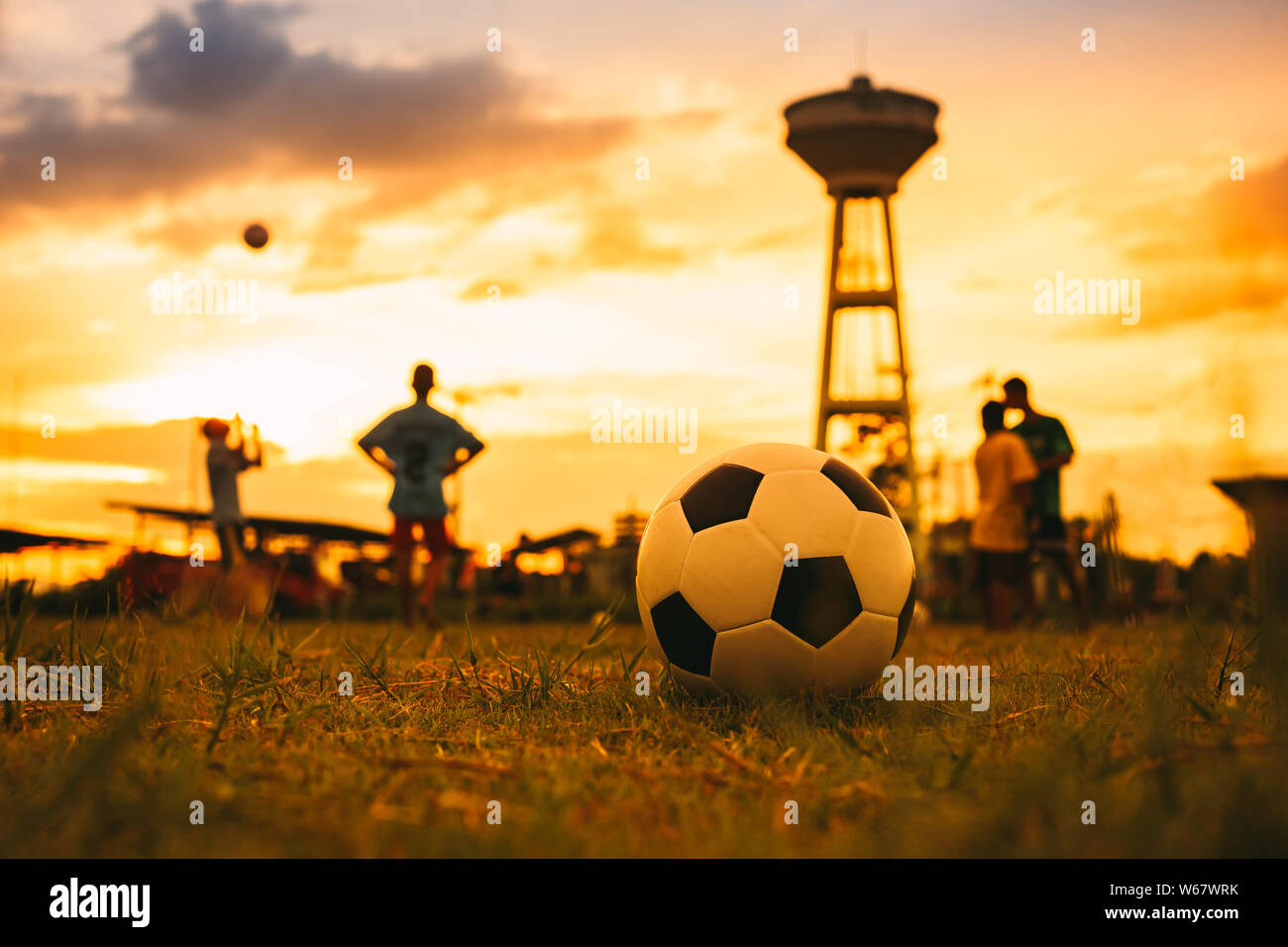 Action sport outdoors of a group of kids having fun playing soccer ...
