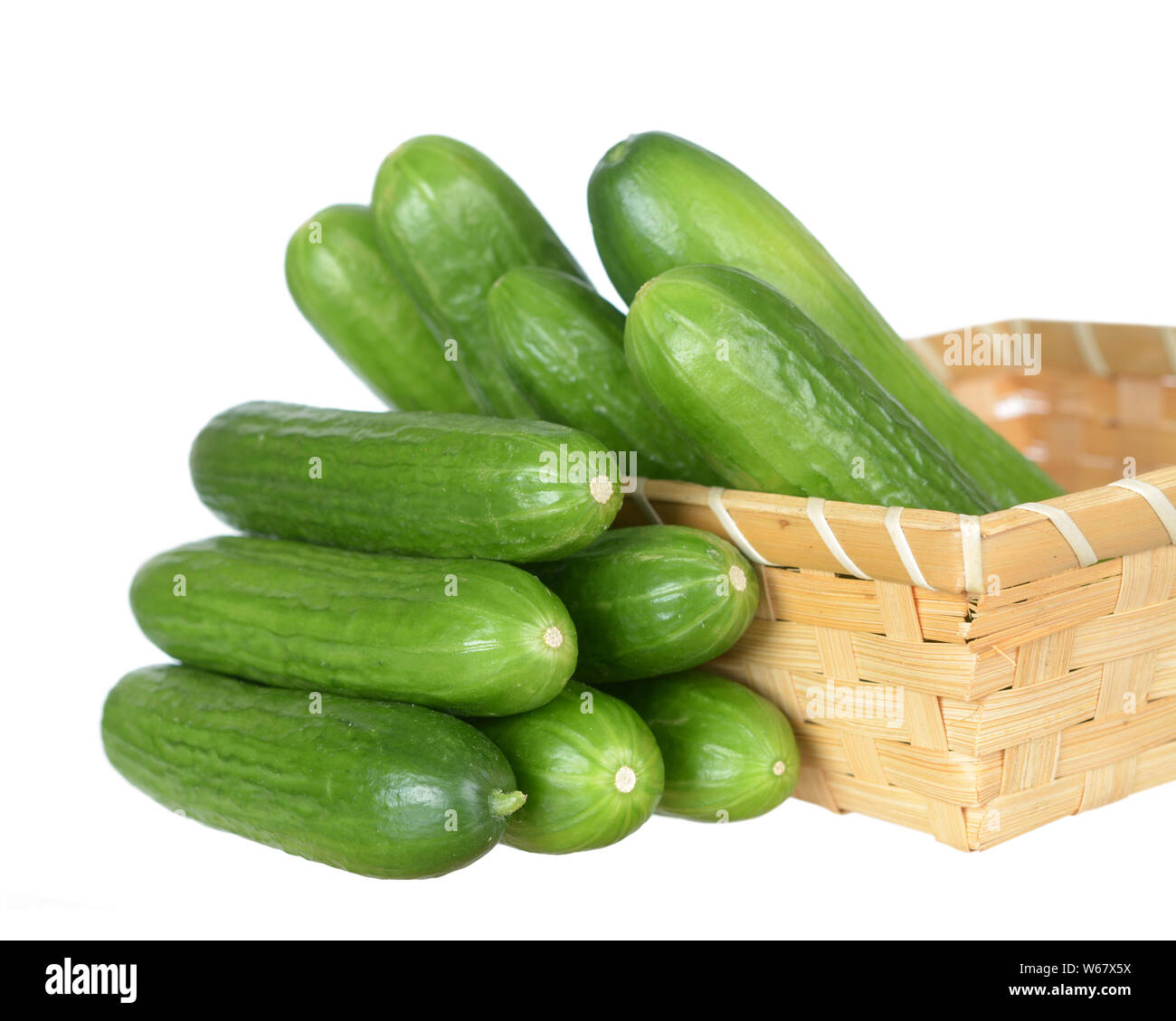 cucumbers in bamboo bucket isolated on white background Stock Photo - Alamy
