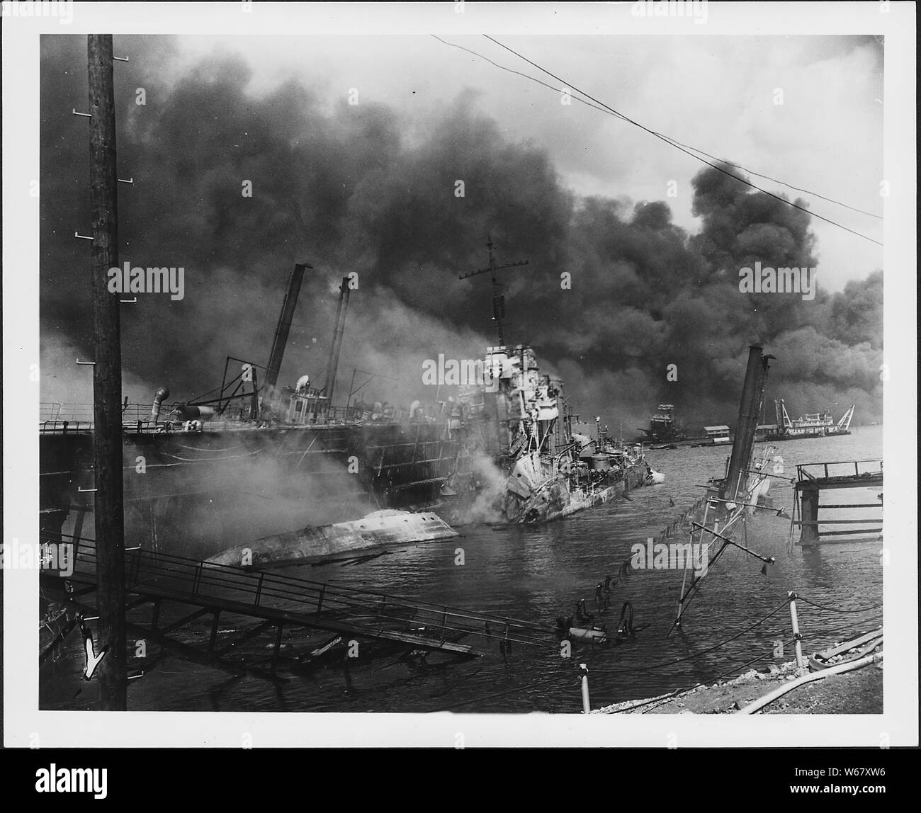 Photograph of the USS Shaw hit by three bombs which exploded in her ...