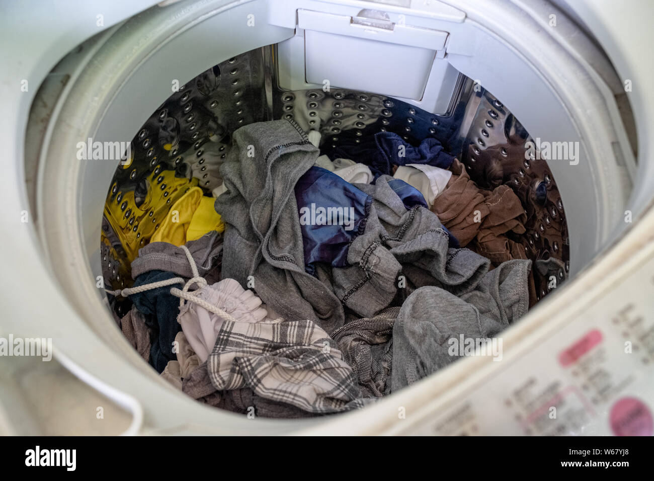 Pile of unclean clothes in washing machine Stock Photo - Alamy