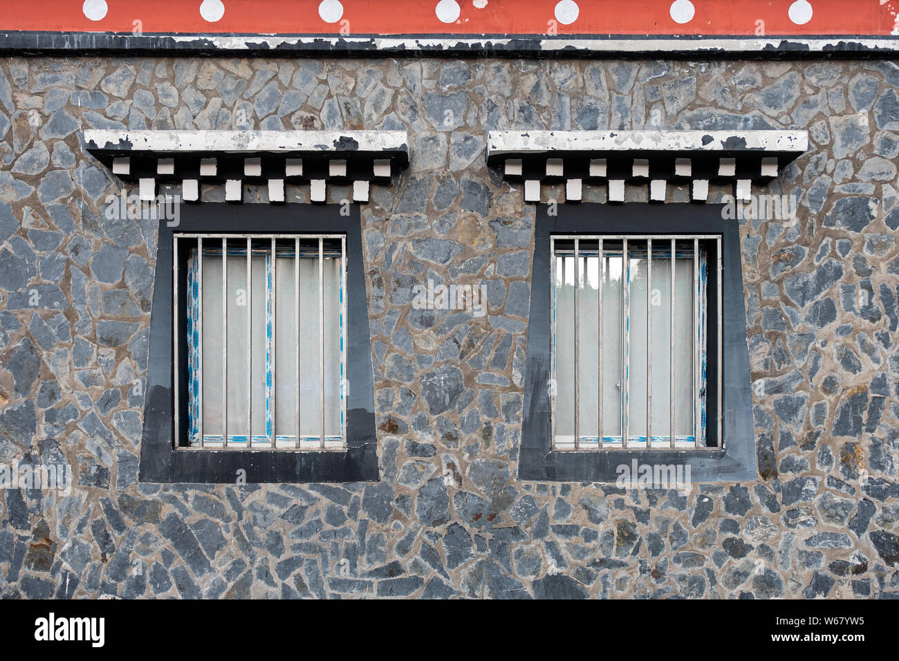 Chinese aged building with grey brick building with steel on windows ...