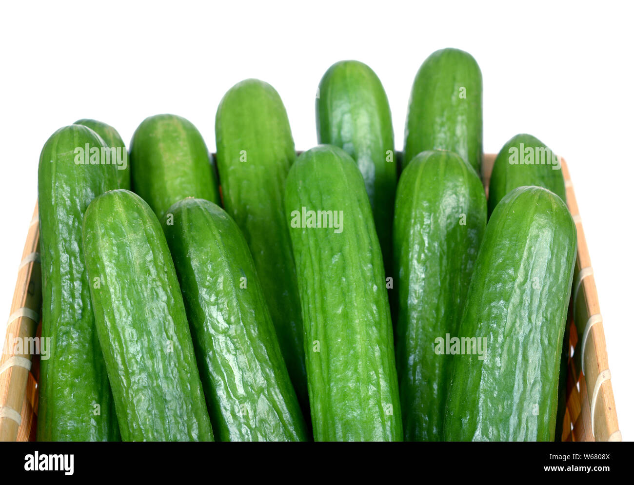 cucumbers in bamboo bucket isolated on white background Stock Photo - Alamy