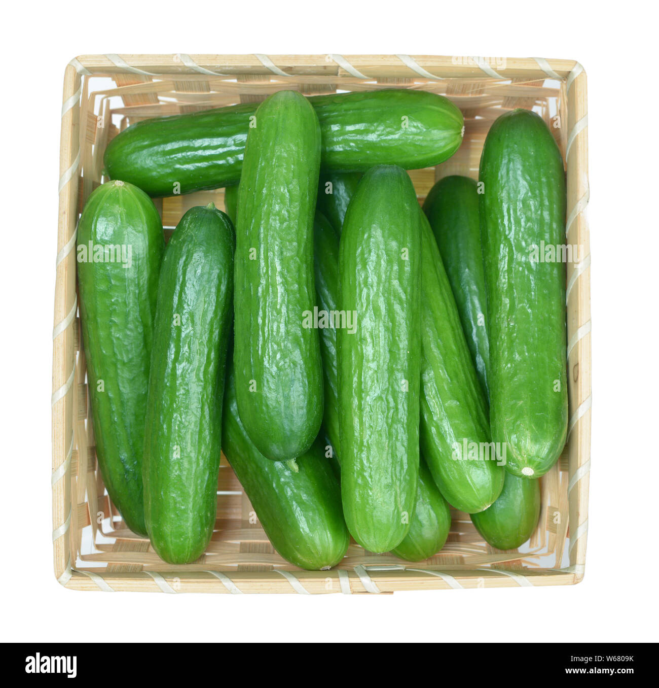 cucumbers in bamboo bucket isolated on white background Stock Photo - Alamy
