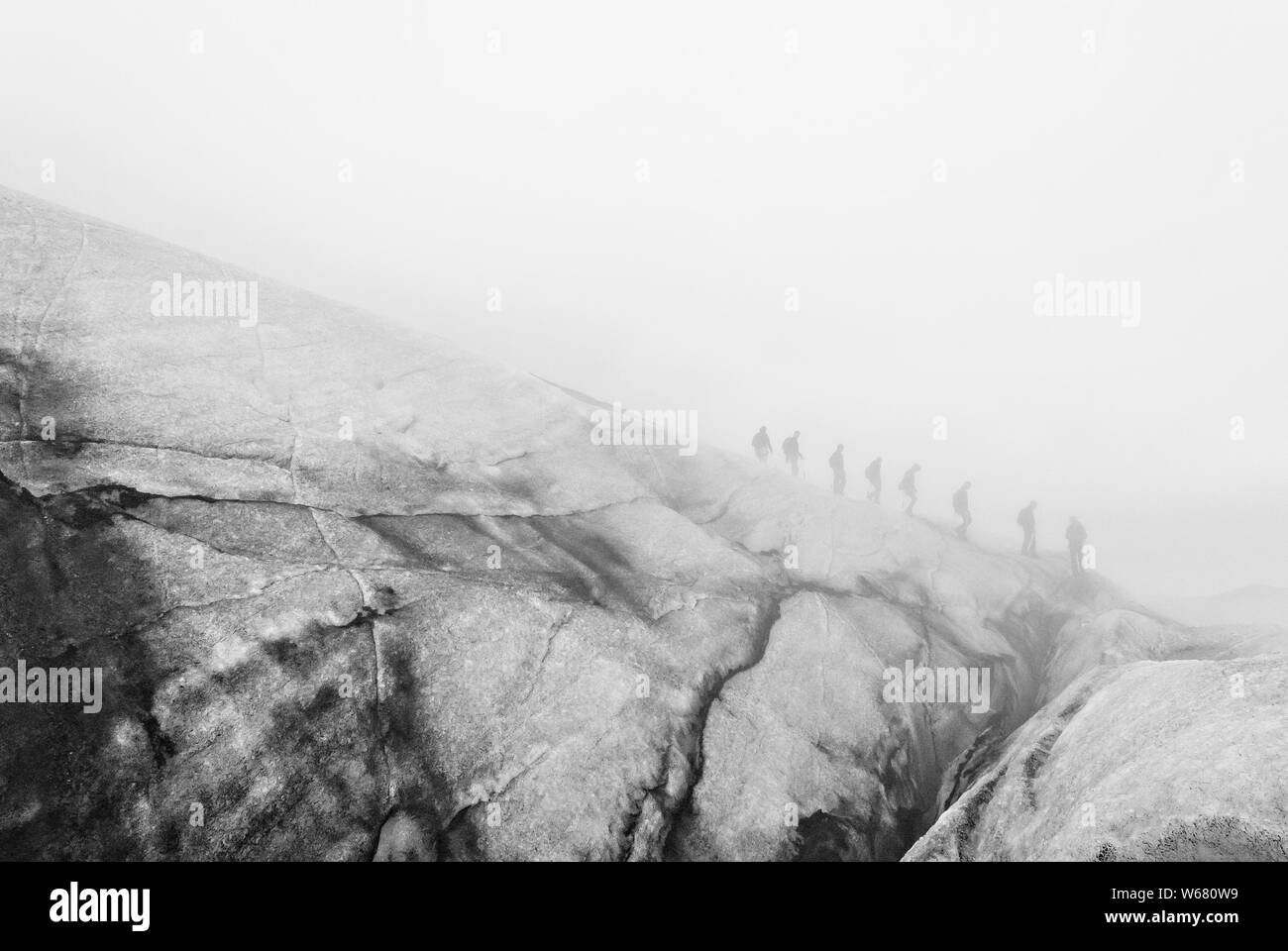 Shadow People hiking, walking through the fog at Vatnajokull, Iceland ...