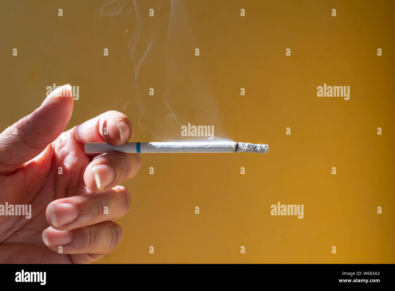 cigarette on hand Stock Photo - Alamy