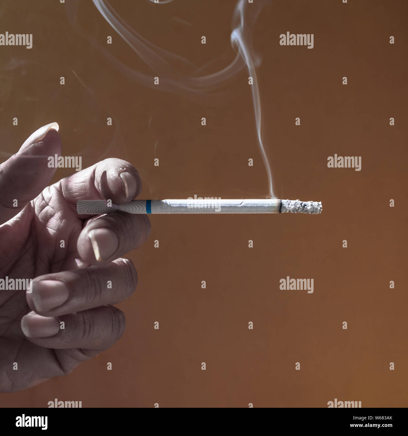 cigarette on hand Stock Photo - Alamy