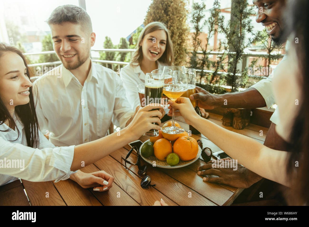 Young group of friends drinking beer, having fun, laughting and ...