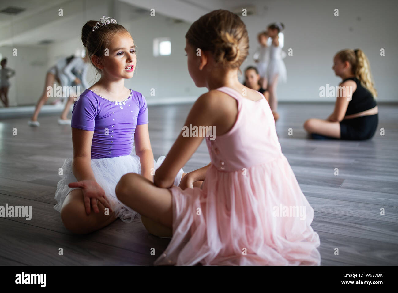 Group of fit happy children exercising ballet in studio together Stock ...