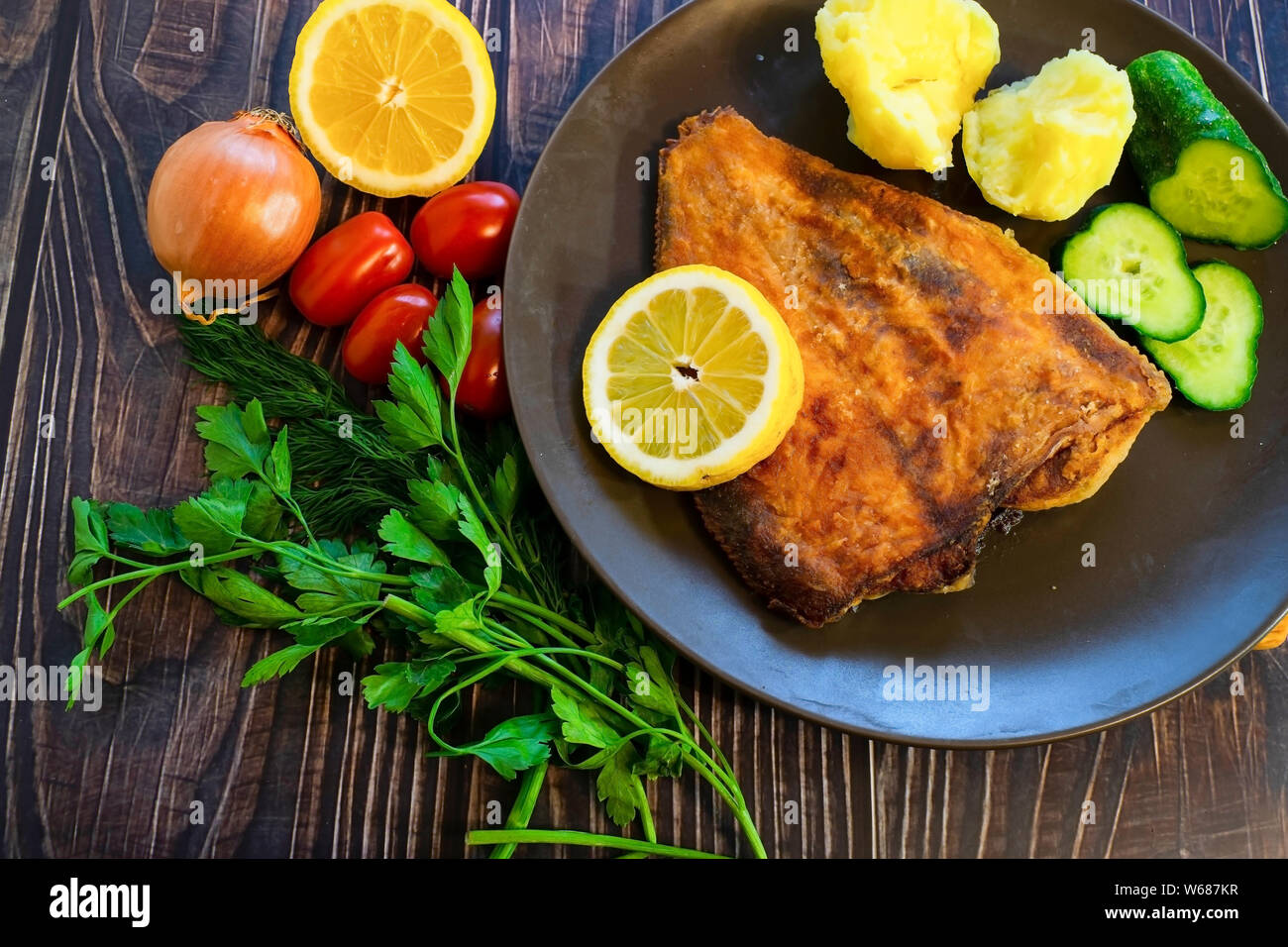 Fried flounder on a plate. Home cooking in a rustic style Stock Photo ...