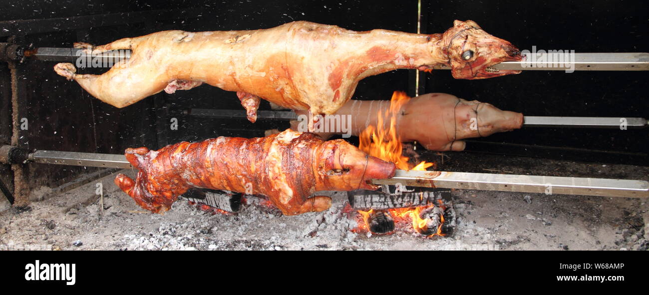 a fresh lamb and a pig on a grill Stock Photo - Alamy