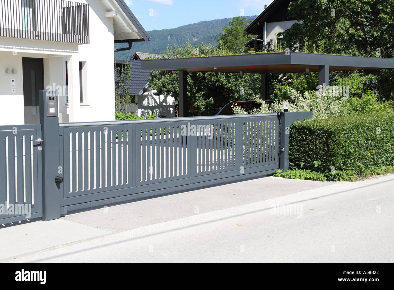 a new house with a metal sliding gate Stock Photo - Alamy