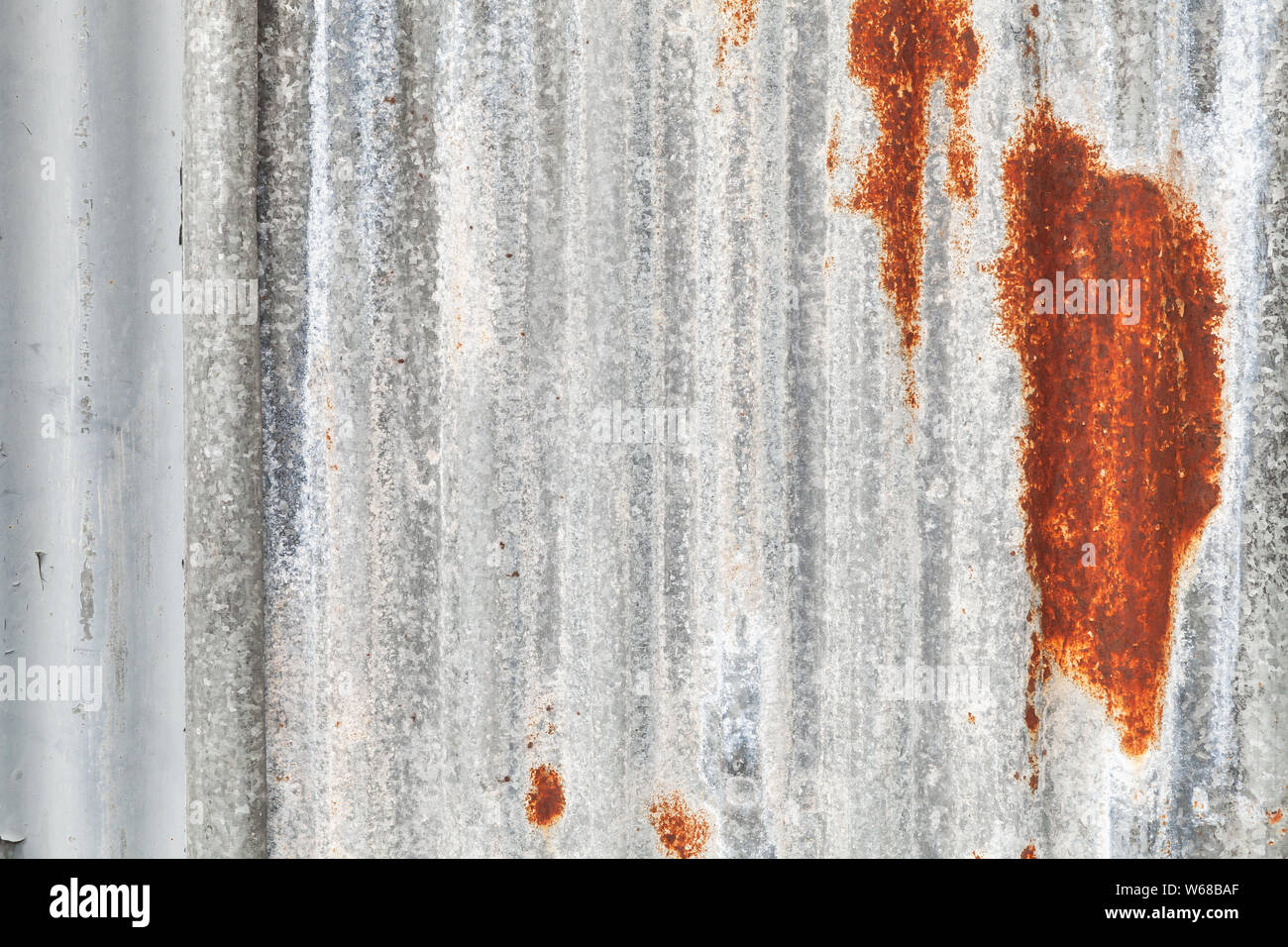 Old gray corrugated metal wall with rust spots, frontal background ...