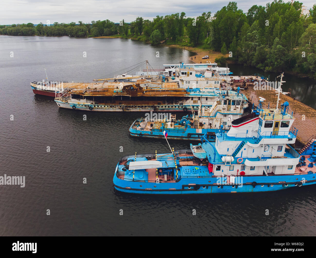Aerial top view Tugboat, Tanker and container ship parking in shipyard ...