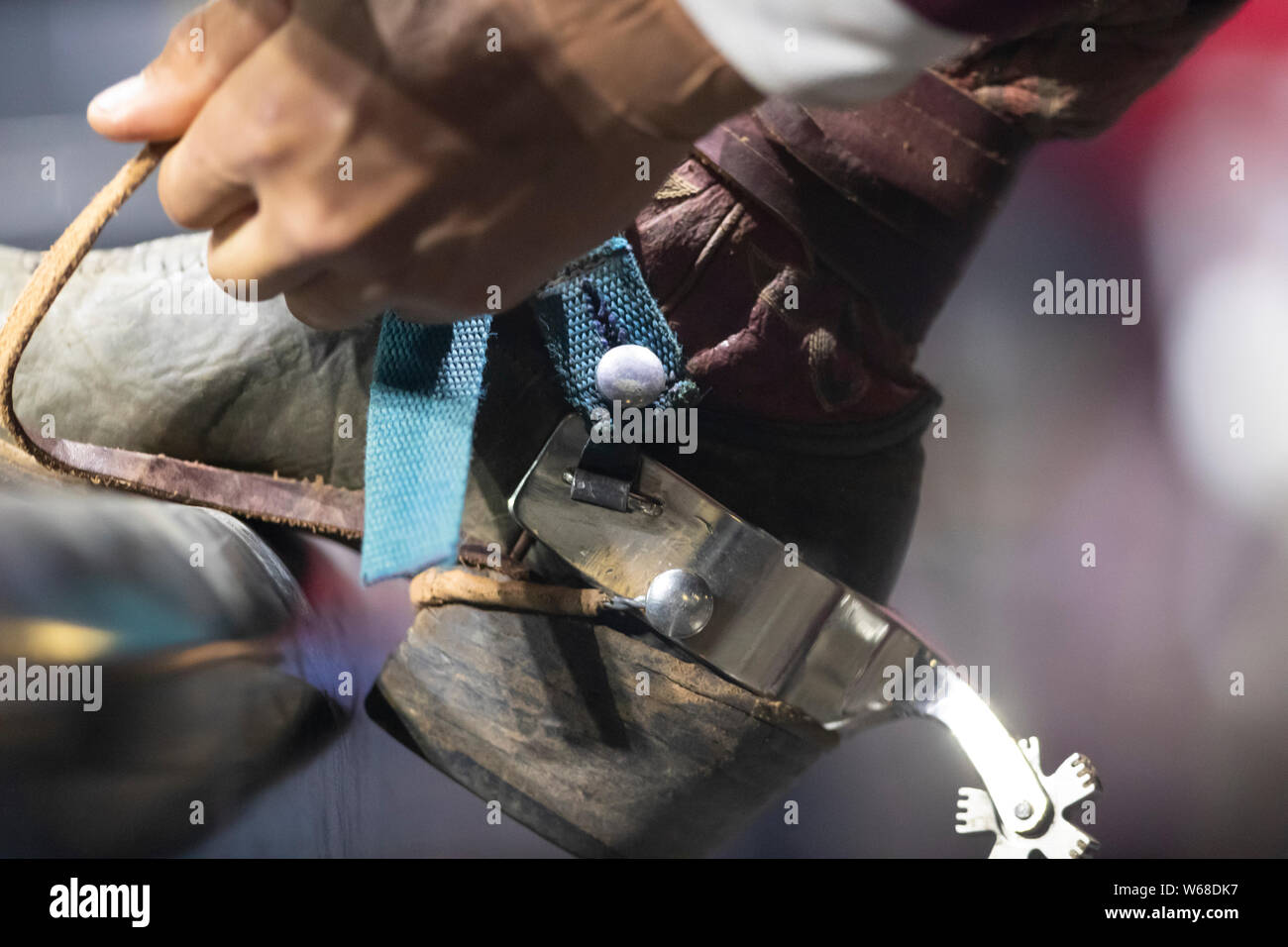 A close up of a cowboy boot and spur on a pipe Stock Photo - Alamy